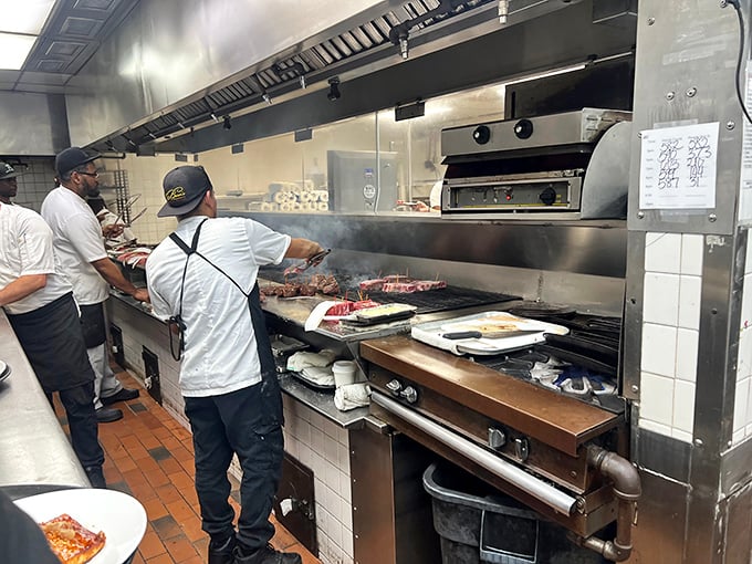 Behind the scenes, the kitchen's controlled chaos reveals where the magic happens. Those flames aren't for show – they're transforming prime beef into dreams.