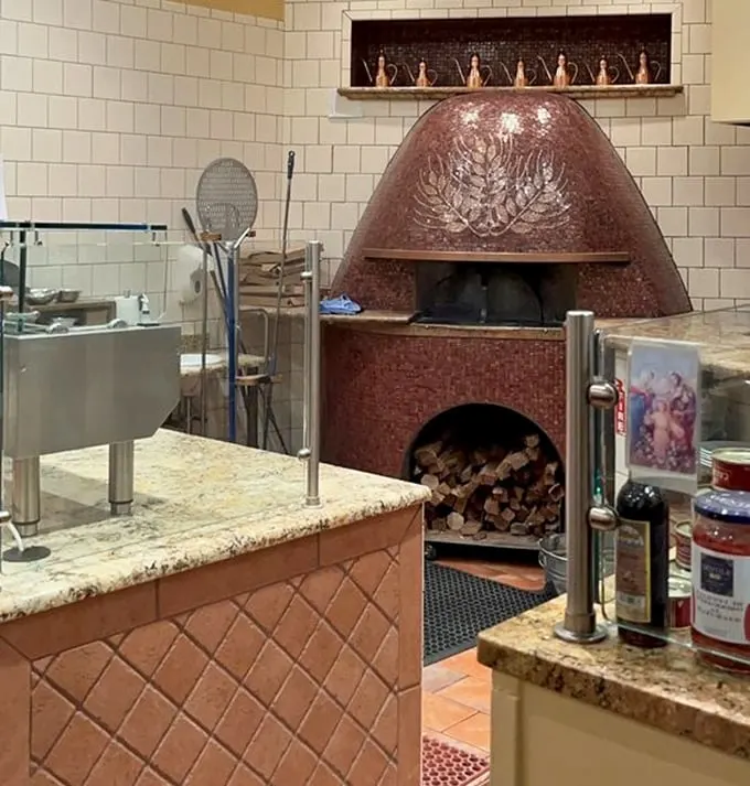 That copper-tiled oven isn't just equipment—it's the beating heart of the restaurant. Naples' soul transported to Chicago.