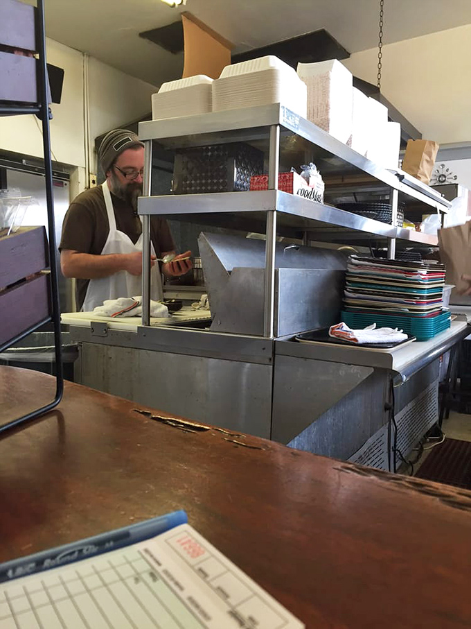The kitchen ballet—where orders become meals through practiced movements and quiet concentration. No molecular gastronomy, just honest cooking.