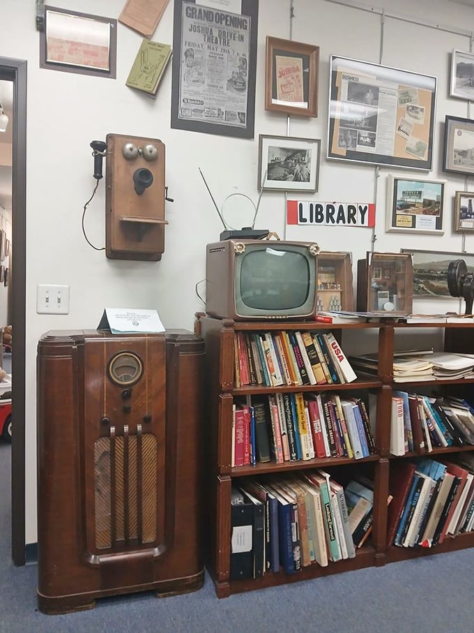 The library corner features a vintage radio, TV, and telephone—communication devices that once seemed as miraculous as today's smartphones.