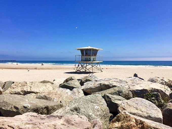 The lifeguard tower stands sentinel over an impossibly perfect beach. Empty sand stretches in both directions—a rare sight on California's typically crowded coastline.