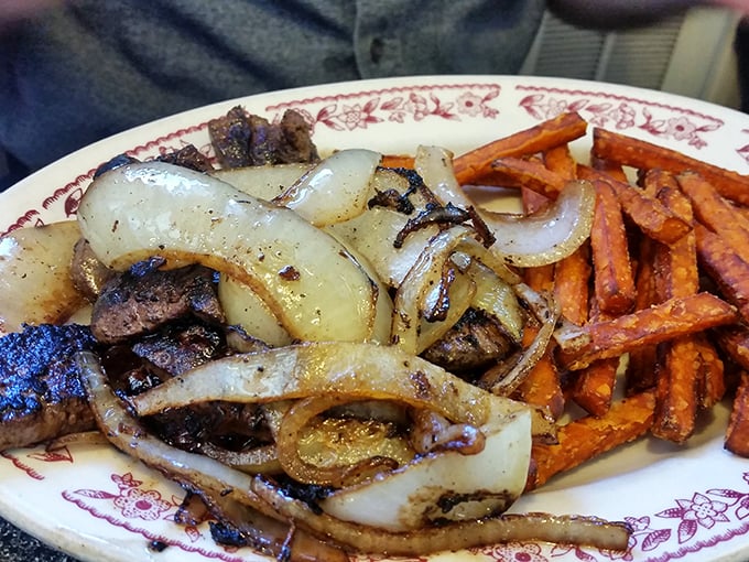 Liver and onions with sweet potato fries—a plate that would make your grandparents nod with approval. Comfort food that's earned its place on the menu.