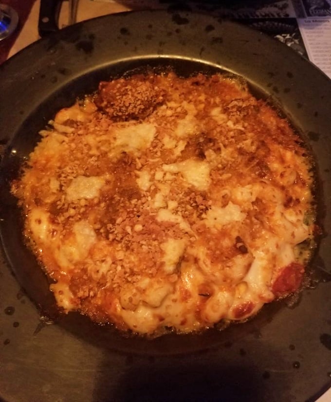 Mac and cheese that's had a serious upgrade—bubbling hot with a golden crust that makes you want to fight your dining companions for the corner piece.
