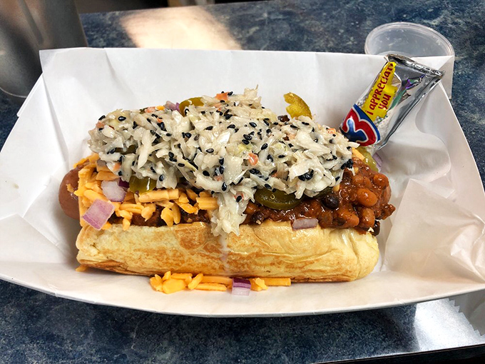 Layer upon layer of toppings create a skyscraper of flavor. This isn't just a hot dog—it's an architectural marvel for your mouth.