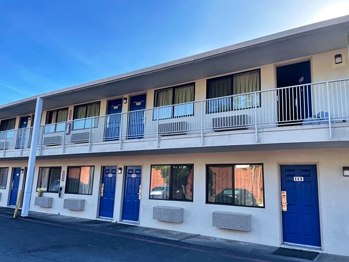 The blue doors of this motel pop against white walls like a Mediterranean getaway that somehow landed in Northern California. Budget-friendly doesn't mean boring.