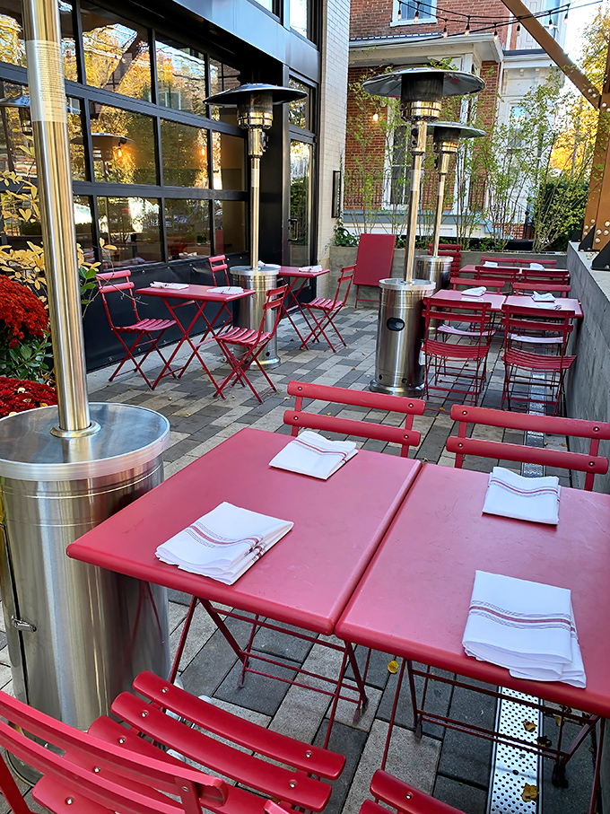 The outdoor patio with its cherry-red tables feels like stumbling upon a secret European café. Even the air tastes better out here.