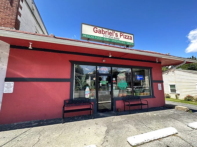 Outdoor benches welcome patrons on sunny Pennsylvania days. The vibrant red building serves as a landmark for those guided by their taste buds.