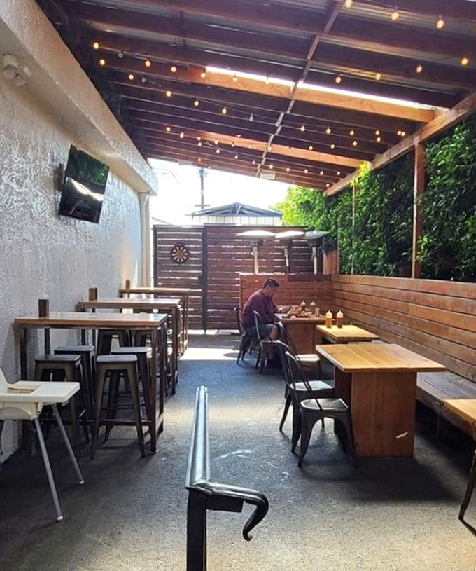 The outdoor patio—where fresh air meets fresh barbecue. A wooden sanctuary for serious eating without judgment.