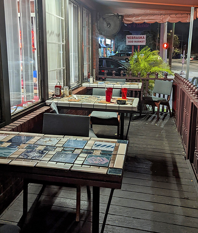 The outdoor patio offers a glimpse of Nebraska Avenue life—mosaic tabletops add artistic flair to your morning coffee ritual.