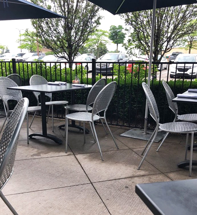 Al fresco dining, Michigan-style – where summer breezes complement every bite and parking lot views come standard.