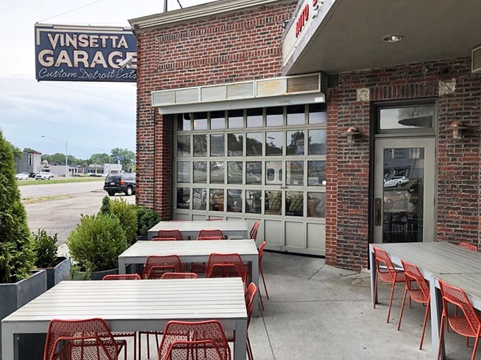 Al fresco dining with a side of automotive history. The garage doors open to create a patio experience that's pure Michigan—casual, cool, and completely charming.