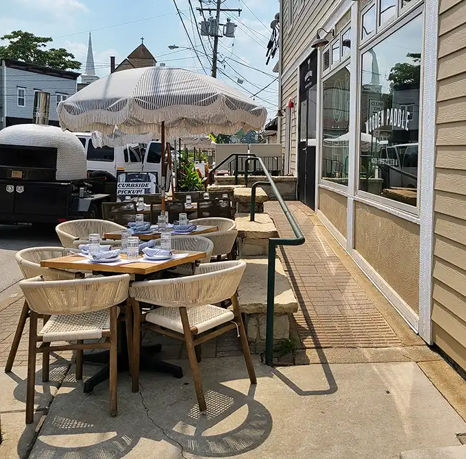 Al fresco dining with a side of small-town charm. Those umbrellas aren't just for shade—they're keeping your pizza safe from envious birds.