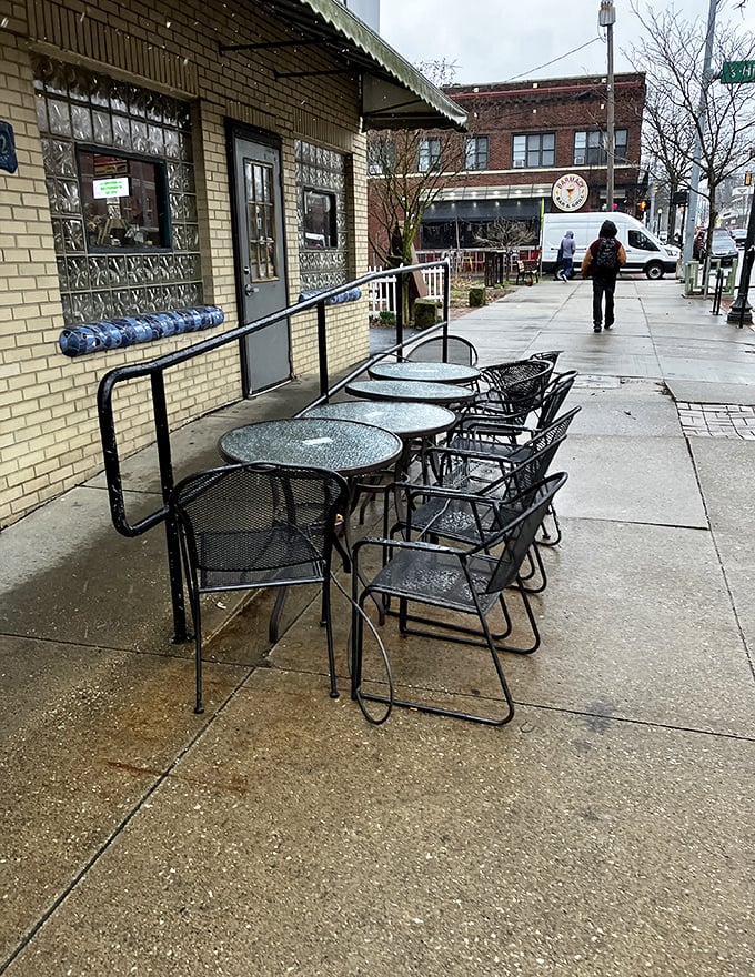 Rain or shine, these sidewalk tables offer front-row seats to Highland Square's daily parade of characters and conversations.