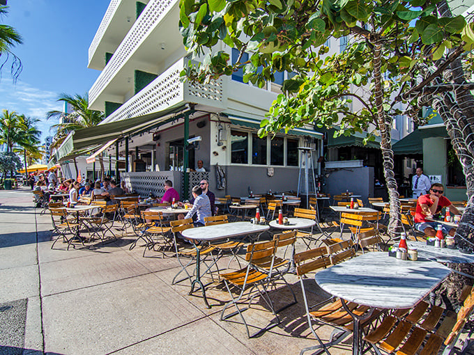Sidewalk seating under Miami's impossibly blue sky. People-watching here is better than anything streaming on your devices right now.