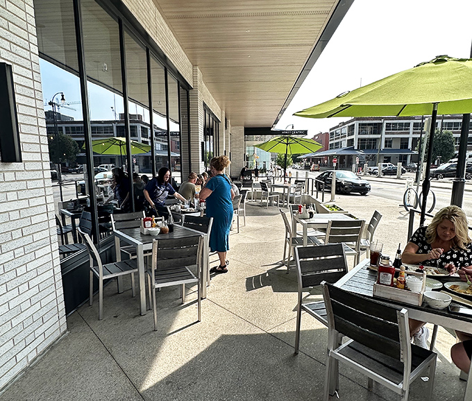 Outdoor seating under lime-green umbrellas—where pancake enthusiasts soak up vitamin D while debating the merits of maple versus blueberry syrup.