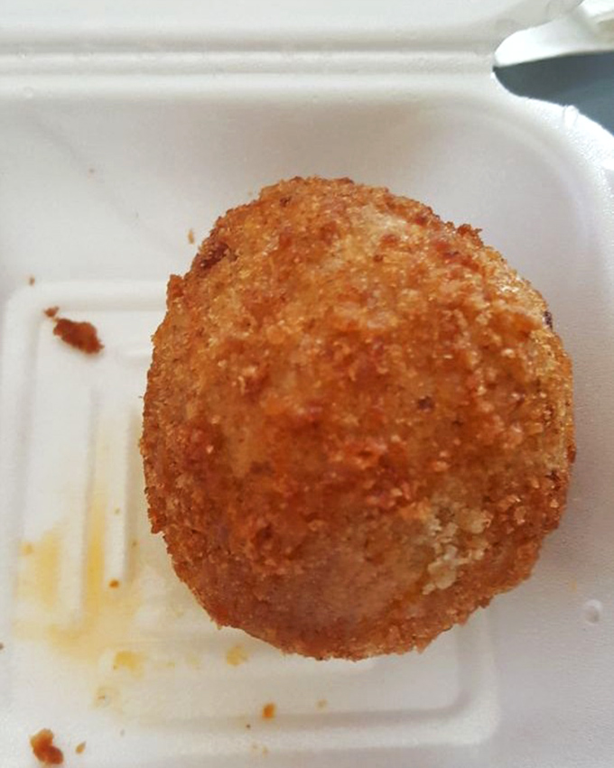 The papa rellena—a golden-fried potato ball—sits like a delicious planet of flavor, gravity pulling your fork inexorably toward it.