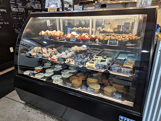 Sweet temptation behind glass! This display case doesn't just hold desserts—it showcases edible art that's almost too pretty to eat.