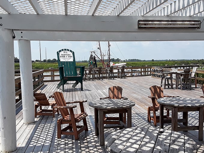 The deck isn't just outdoor seating—it's front-row tickets to nature's best show, with marsh grass and water views included.