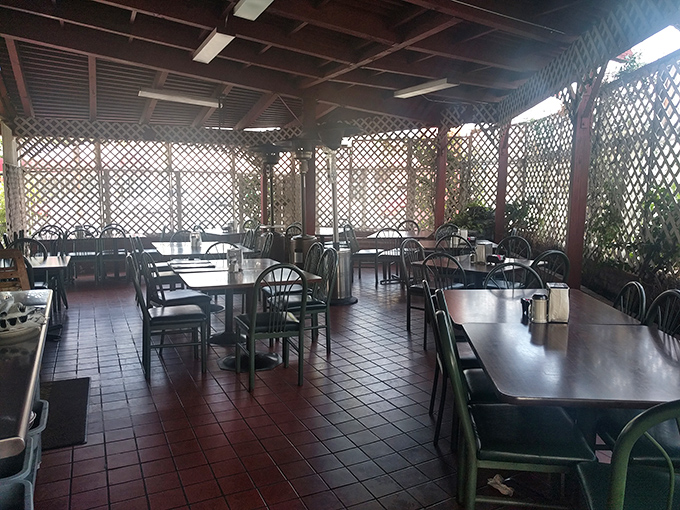 The patio area offers a breezy alternative to indoor dining—latticed walls creating dappled light perfect for lingering over that last bite.