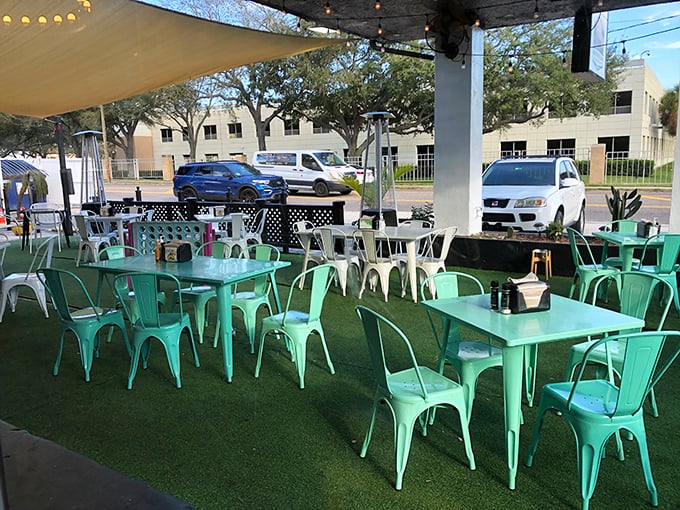 Mint green tables under Florida skies—this outdoor seating area is begging for long conversations and second rounds of coffee.