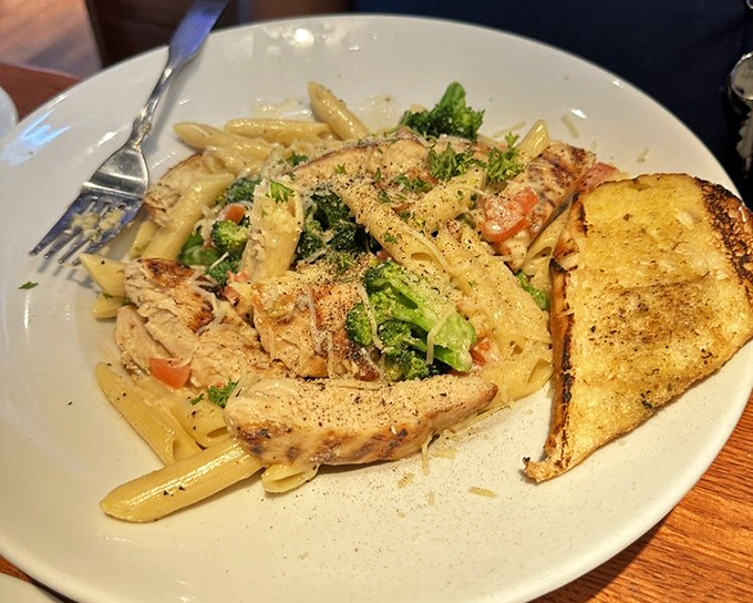 Pasta that doesn't try to be Italian—it's proudly Maryland-American, with grilled chicken and vegetables playing supporting roles to the creamy star.