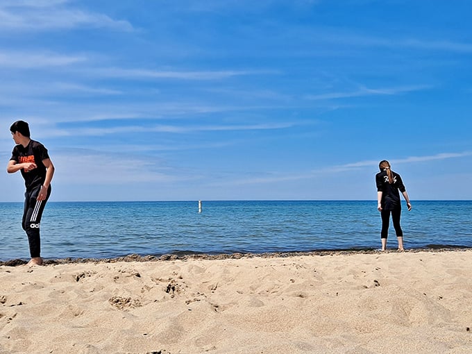 Toes in the sand, worries in retreat. These beachgoers demonstrate the proper technique for testing Lake Michigan's famously brisk waters.
