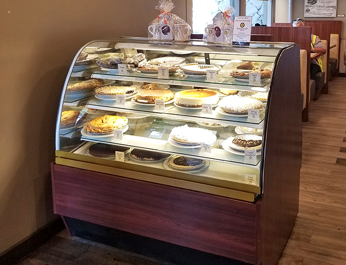 The pie display case—where willpower goes to die and dessert-for-breakfast becomes a perfectly reasonable life choice.