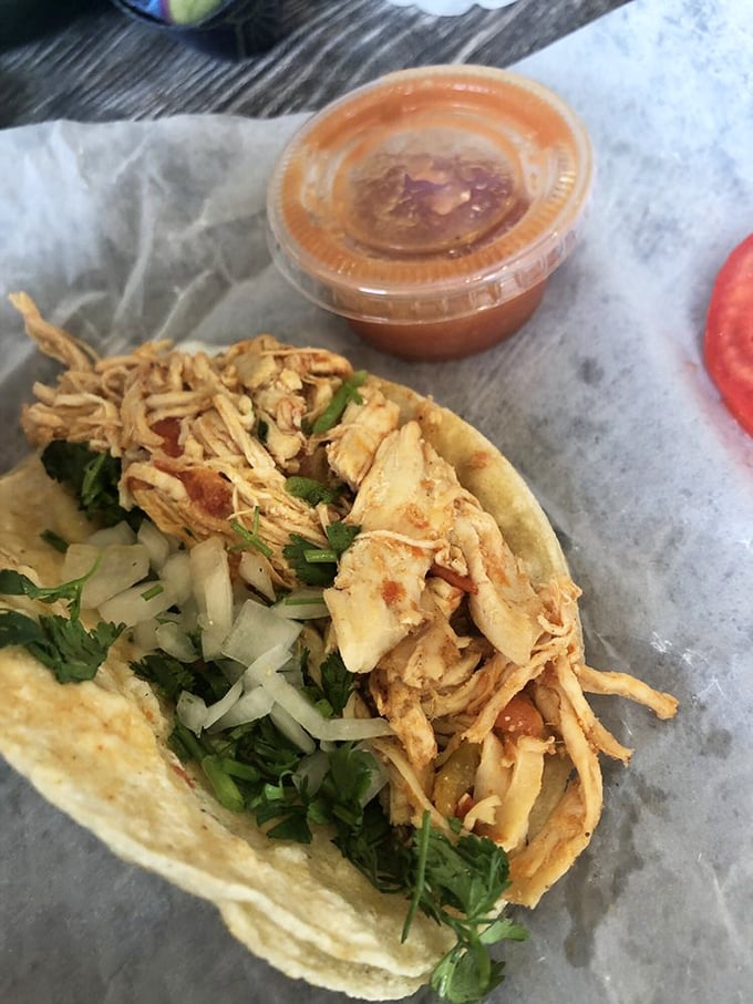 A taco that doesn't need fancy plating—just handmade tortillas, tender chicken, and enough cilantro to make your taste buds dance.