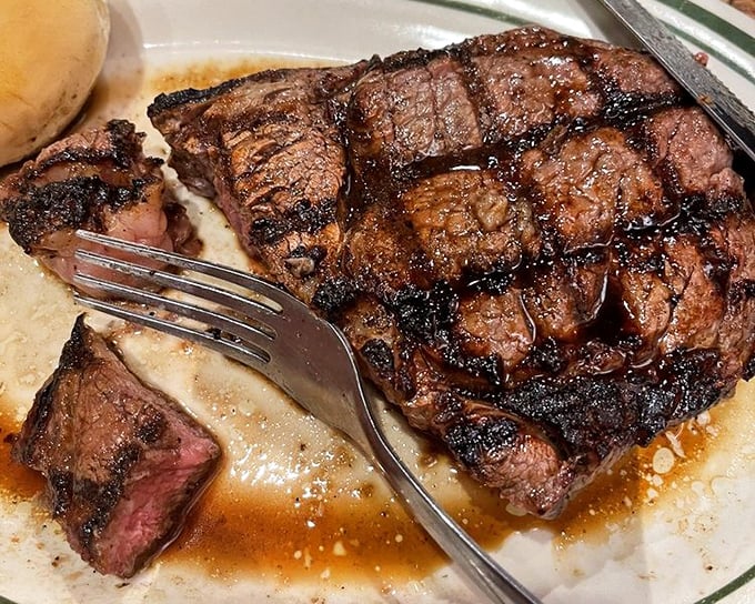 This ribeye isn't just cooked—it's been lovingly persuaded to perfection, with those grill marks telling a story of flame-kissed excellence.