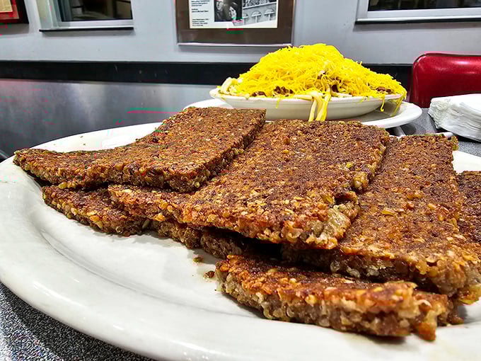 Scrapple slices fried to crispy perfection—a hearty breakfast tradition that turns humble ingredients into morning gold.