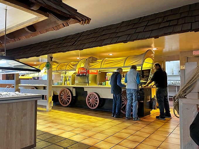 Three gentlemen at the self-service counter, participating in the time-honored tradition of carefully considering each salad bar option's merits.