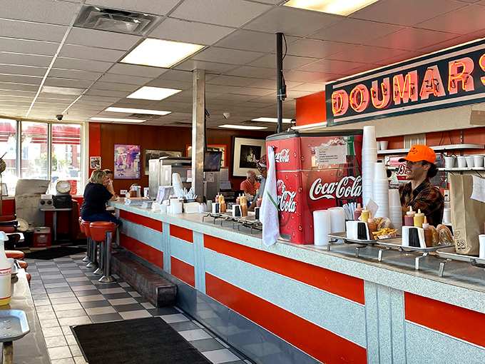 The counter where magic happens—a front-row seat to American food theater where servers move with the practiced choreography of people who love what they do.
