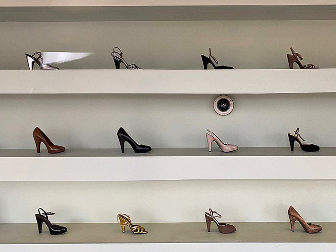 These shoes weren't made for walking—they're permanent residents of the desert, displayed like artifacts from a civilization obsessed with status and style.