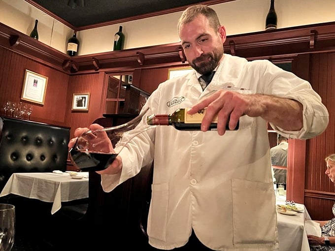 The sommelier's pour—that theatrical moment when the wine meets glass and anticipation builds for the feast to come. 