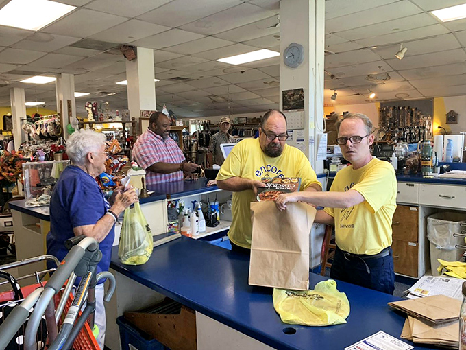 The unsung heroes of thrift! Encore's yellow-shirted staff doesn't just ring up your treasures—they're the curators of this museum of affordable possibilities.