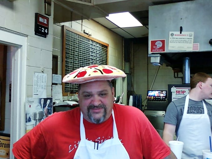 Behind every great neighborhood pizzeria is someone who treats dough like an art form. That pizza hat isn't just fun—it's truth in advertising.