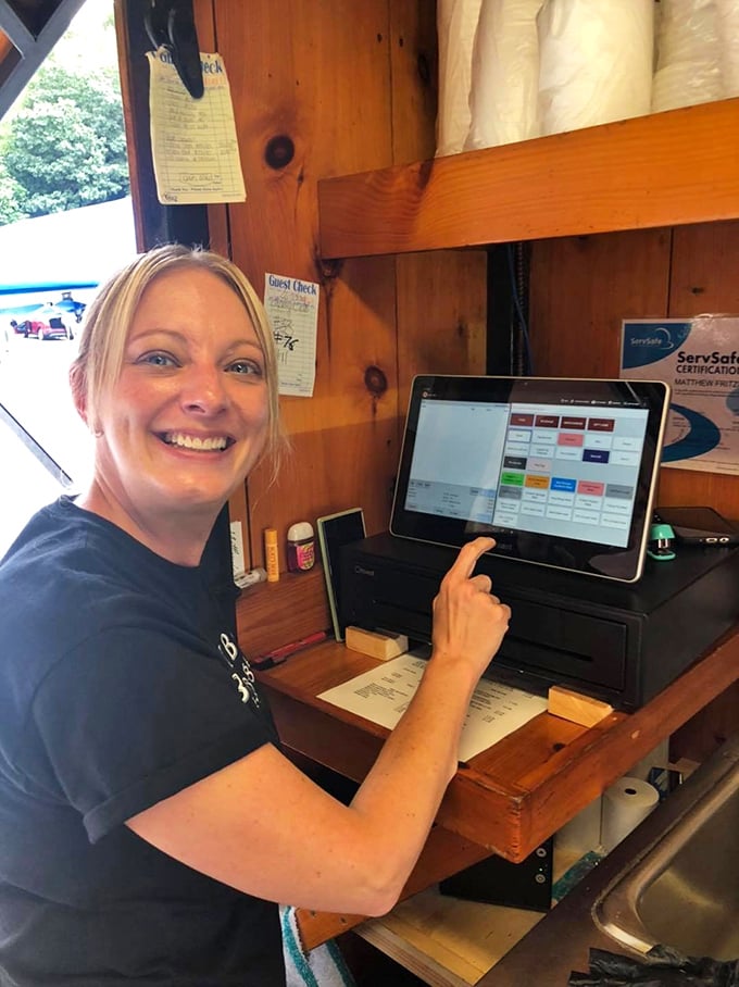 The smile says it all—when you're slinging barbecue this good, every order is a chance to make someone's day memorably delicious.