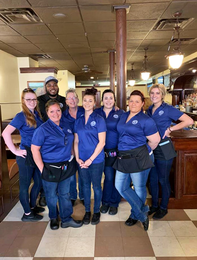 The team behind the magic, sporting matching blue polos and genuine smiles. These folks aren't just servers—they're stewards of your evening's enjoyment.
