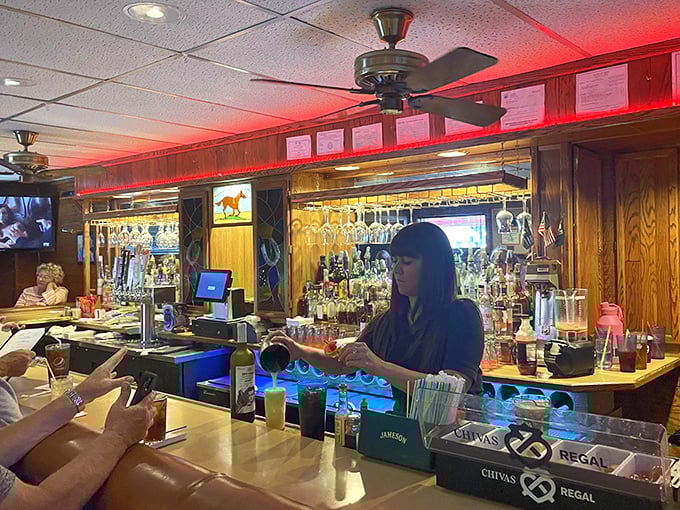 Behind every great bar is someone who knows exactly what you're going to order before you do. The red lighting isn't ambiance—it's tradition.