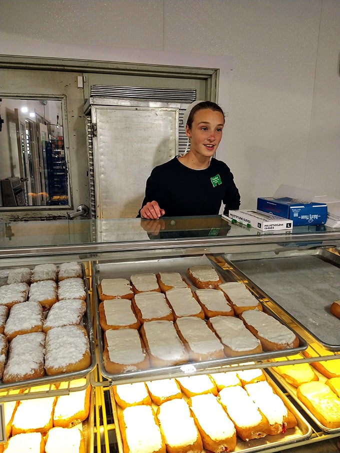 The smile says it all—these aren't just pastries, they're pride in physical form. That frosting isn't just sweet; it's someone's craftsmanship.
