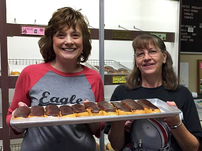 The proud faces behind the donuts showcase the true secret ingredient—people who care enough to get up at ungodly hours to make your morning special.