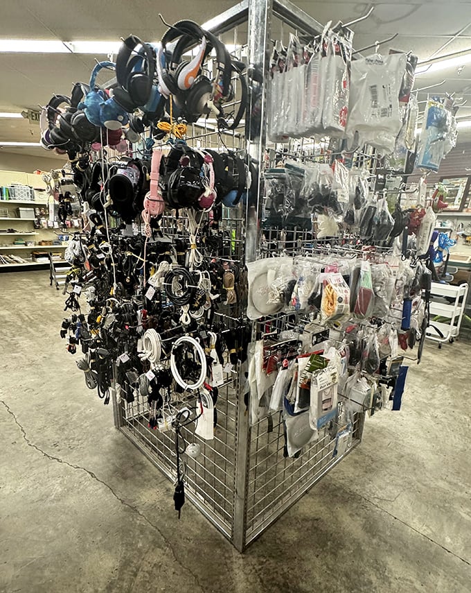 The accessories wall – a hanging garden of headphones, chargers, and gadget companions. Technology's version of an island of misfit toys seeking new homes.