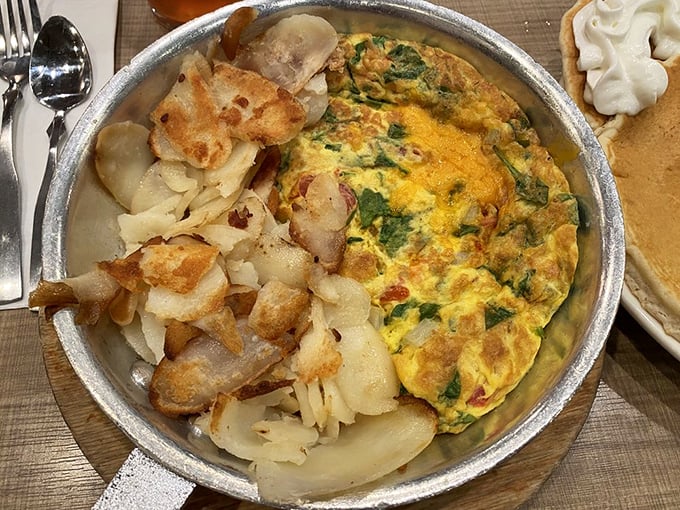 This isn't just an omelet – it's a skillet of morning joy with perfectly crisped potatoes that would make any grandmother nod in approval.
