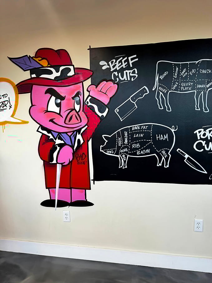 Educational wall art teaches diners about cuts while a cartoon pig mascot adds whimsical charm.