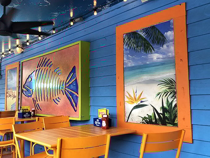 Tropical wall art that says "beach vacation" without the sunburn – blue walls bringing ocean vibes indoors year-round.