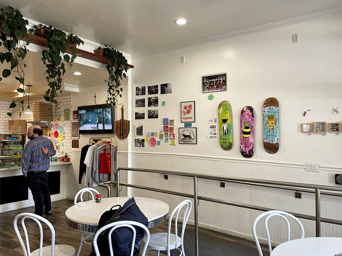 Skateboard decks and framed photos create a gallery wall of urban cool. The kind of place that feels like it's been part of the neighborhood forever.