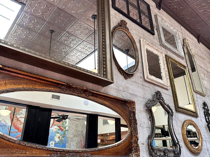 The eclectic collection of mirrors doesn't just decorate – it expands the space while reflecting all those "oh my goodness" food reactions.