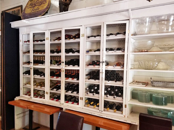 Wine bottles standing at attention behind chicken wire – rustic storage meets sophisticated selection in this charming display cabinet.