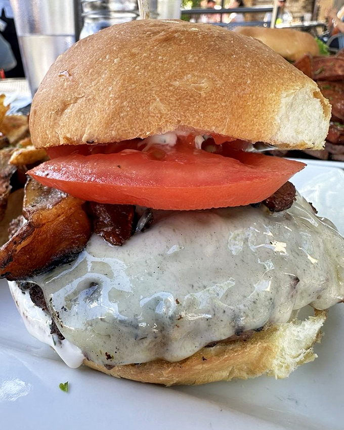 This isn't just a burger—it's a testament to the power of proper cheese-to-meat ratio and the importance of a tomato slice that means business.