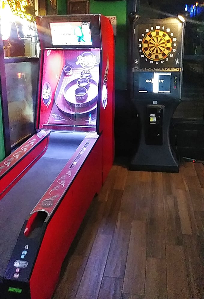 Where friendly competition lives between bites – vintage arcade games and electronic darts await those needing to settle friendly wagers.